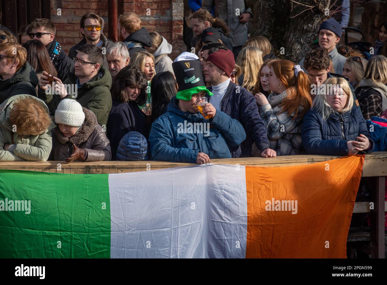 Boy with big hat drinking beer during Irish St. Patrick's Day ...