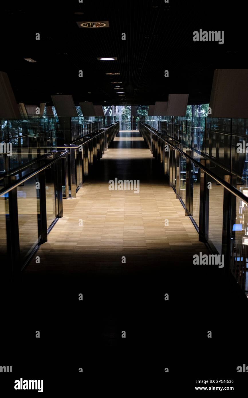 Long straight corridor on a dark interior scene building Stock Photo ...