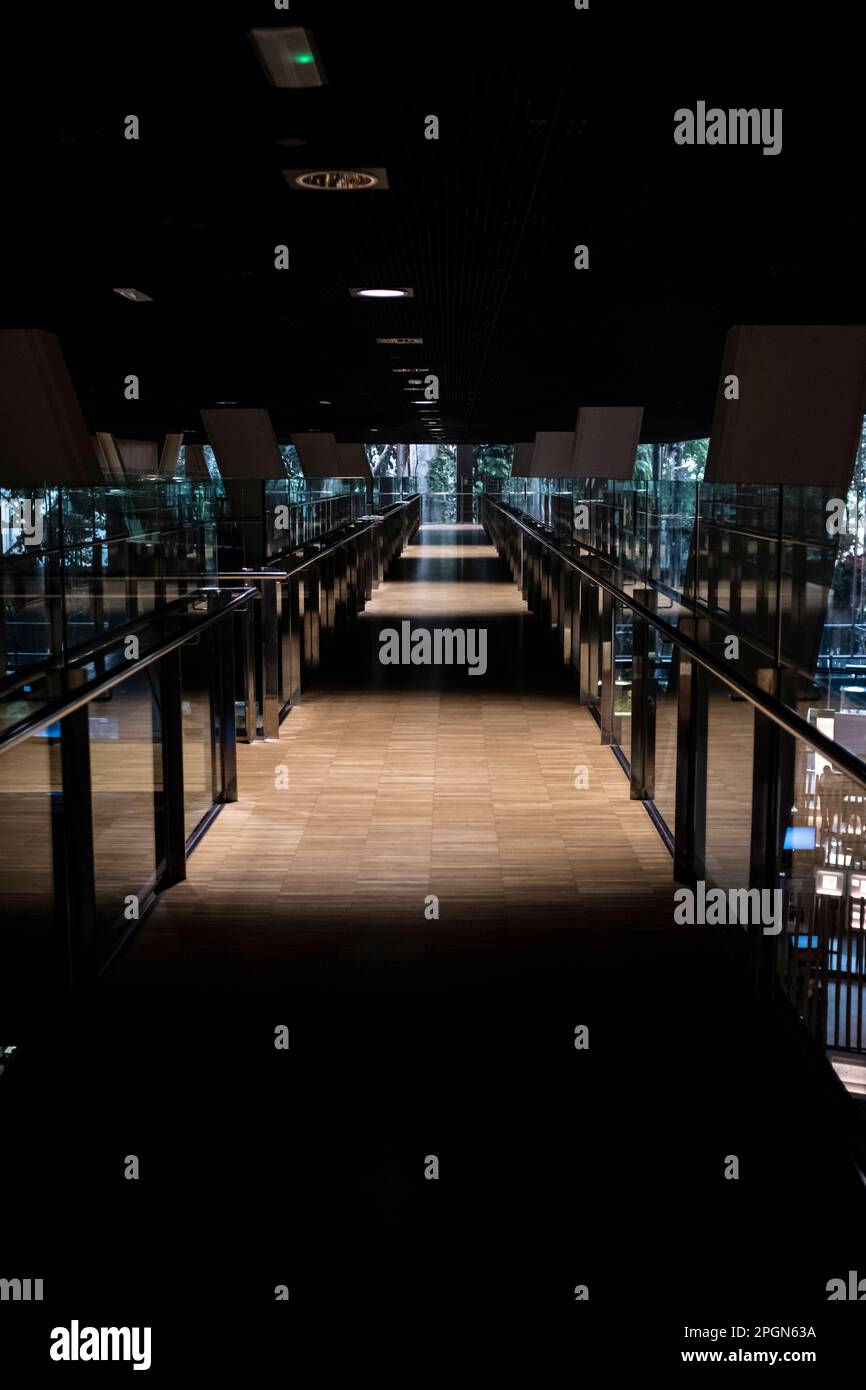 Long straight corridor on a dark interior scene building Stock Photo ...