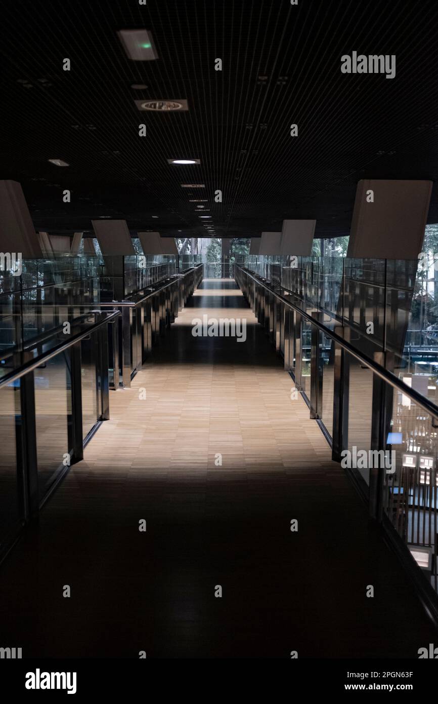 Long straight corridor on a dark interior scene building Stock Photo ...