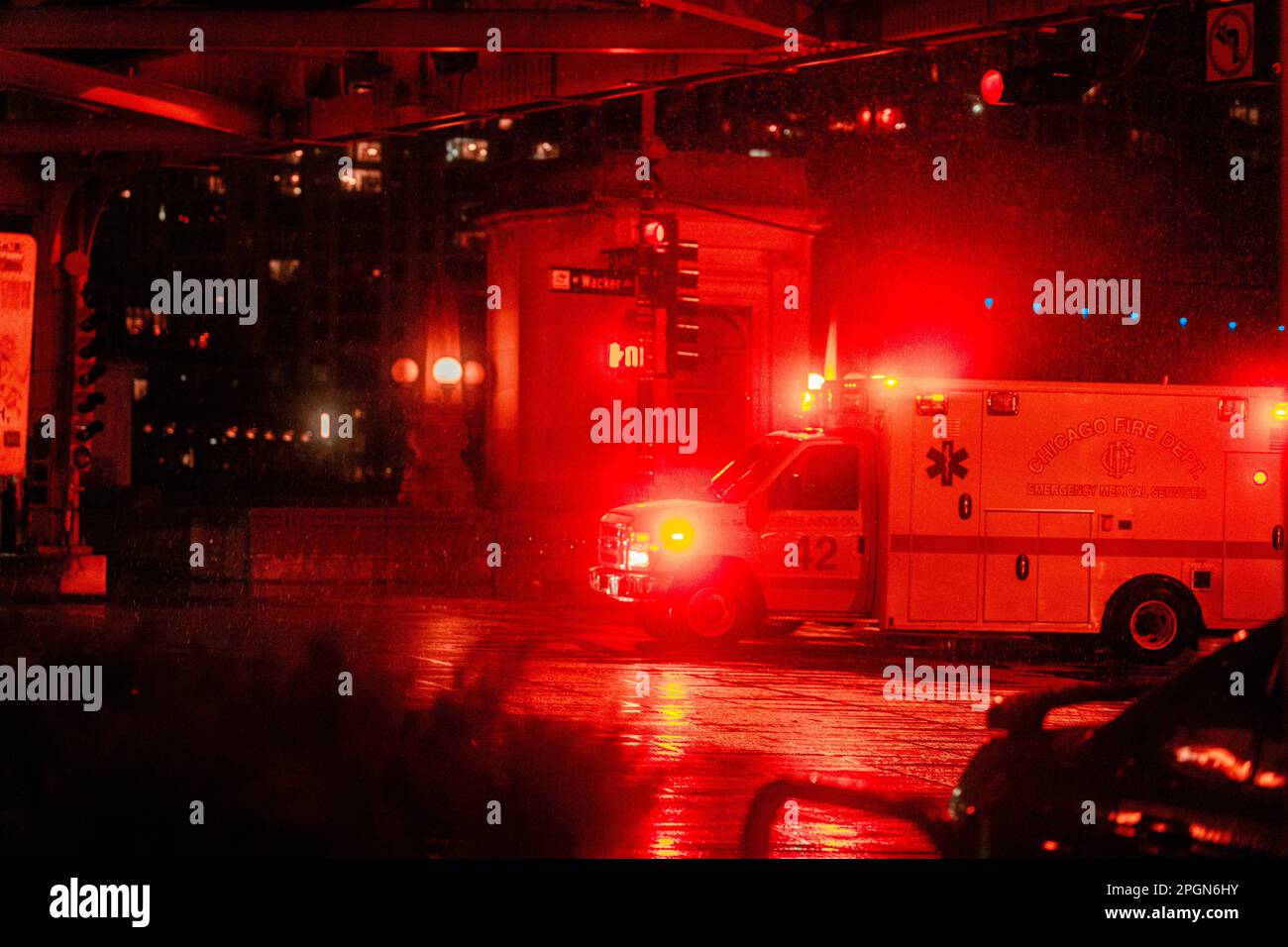 A view of an ambulance illuminated by bright red street lights Stock ...