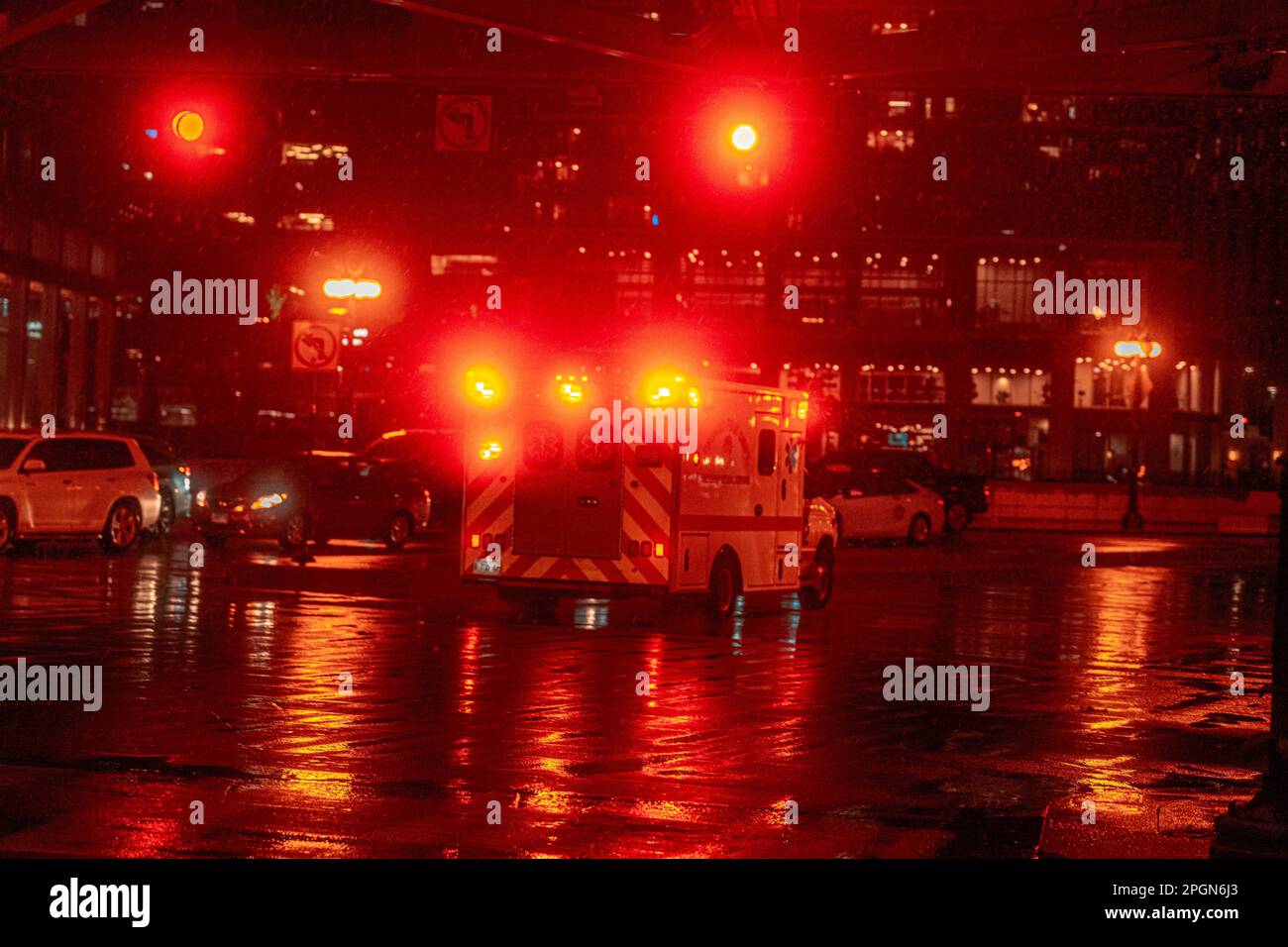 A view of an ambulance illuminated by bright red street lights Stock ...