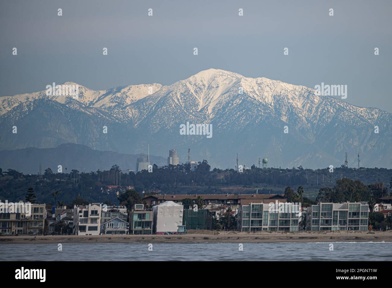 Snow capped mountains form backdrop to Los Angeles skyline (DTLA) and ...