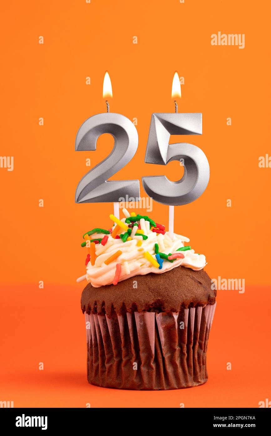 Candle number 25 - Cake birthday in orange background Stock Photo - Alamy