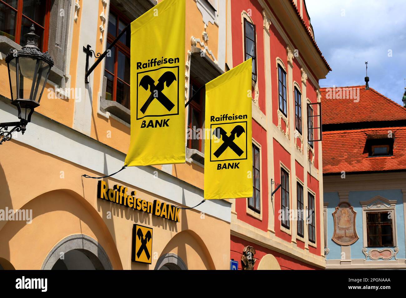 Raiffeisen Bank, branch in the medieval town. Signboard and flags large ...