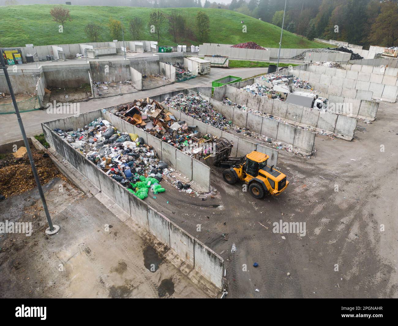 Handling construction waste on the landfill site, skid steer loader ...