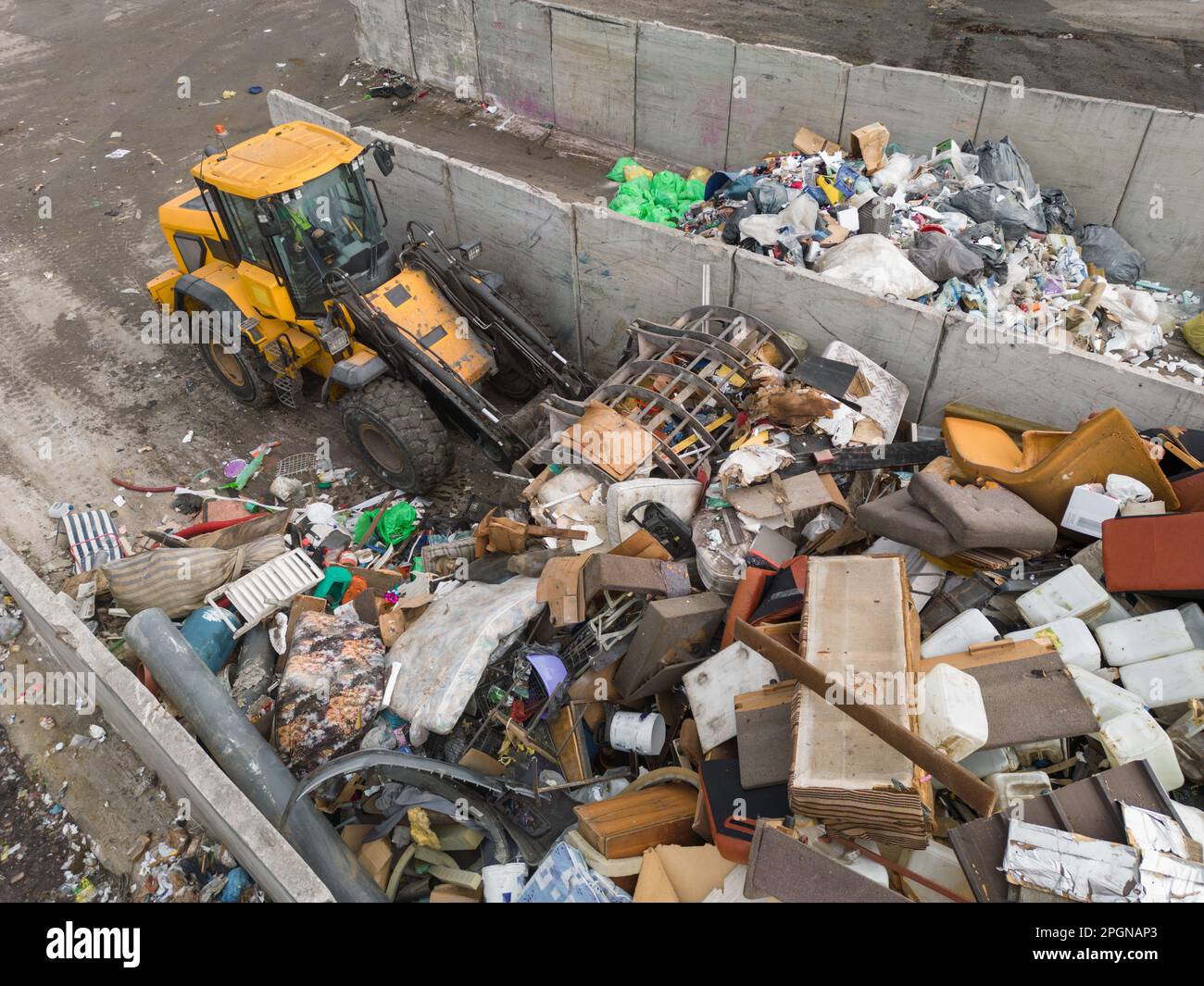 Handling construction waste on the landfill site, skid steer loader ...