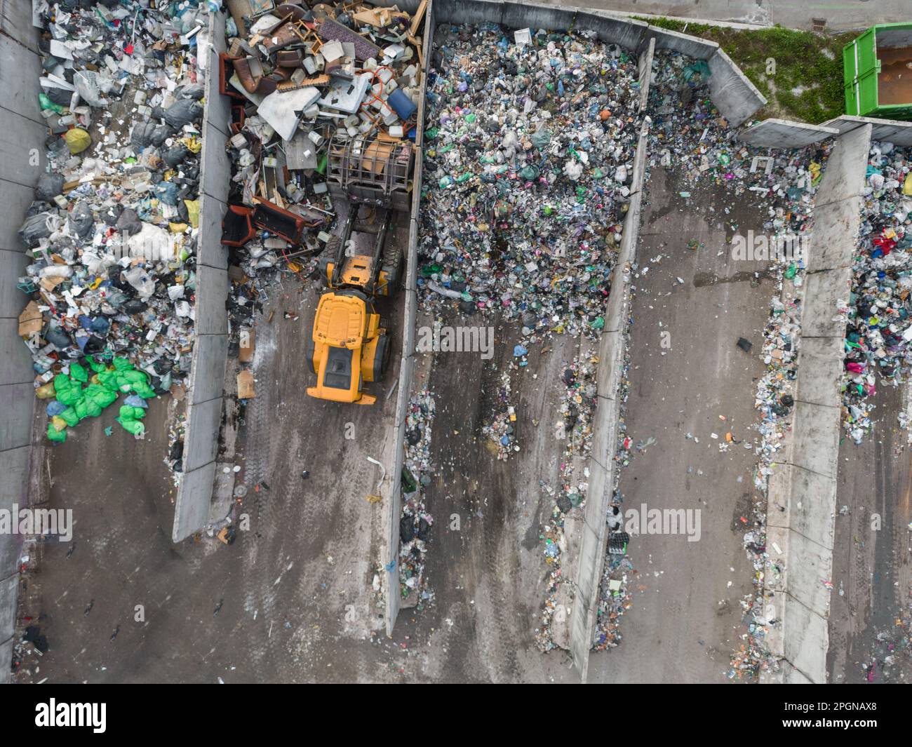 Wheel loader on the landfill site, pushing, scooping and carrying waste ...