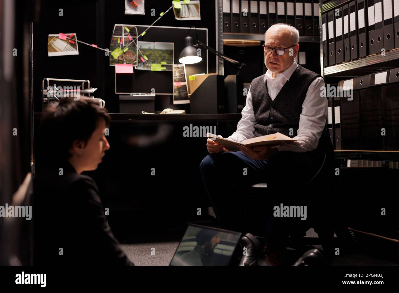 Woman inspector analyzing suspect evidence on laptop computer, working ...