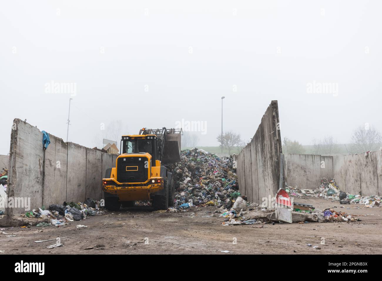 Front loader with scrap handling grapple bucket moving forward and ...
