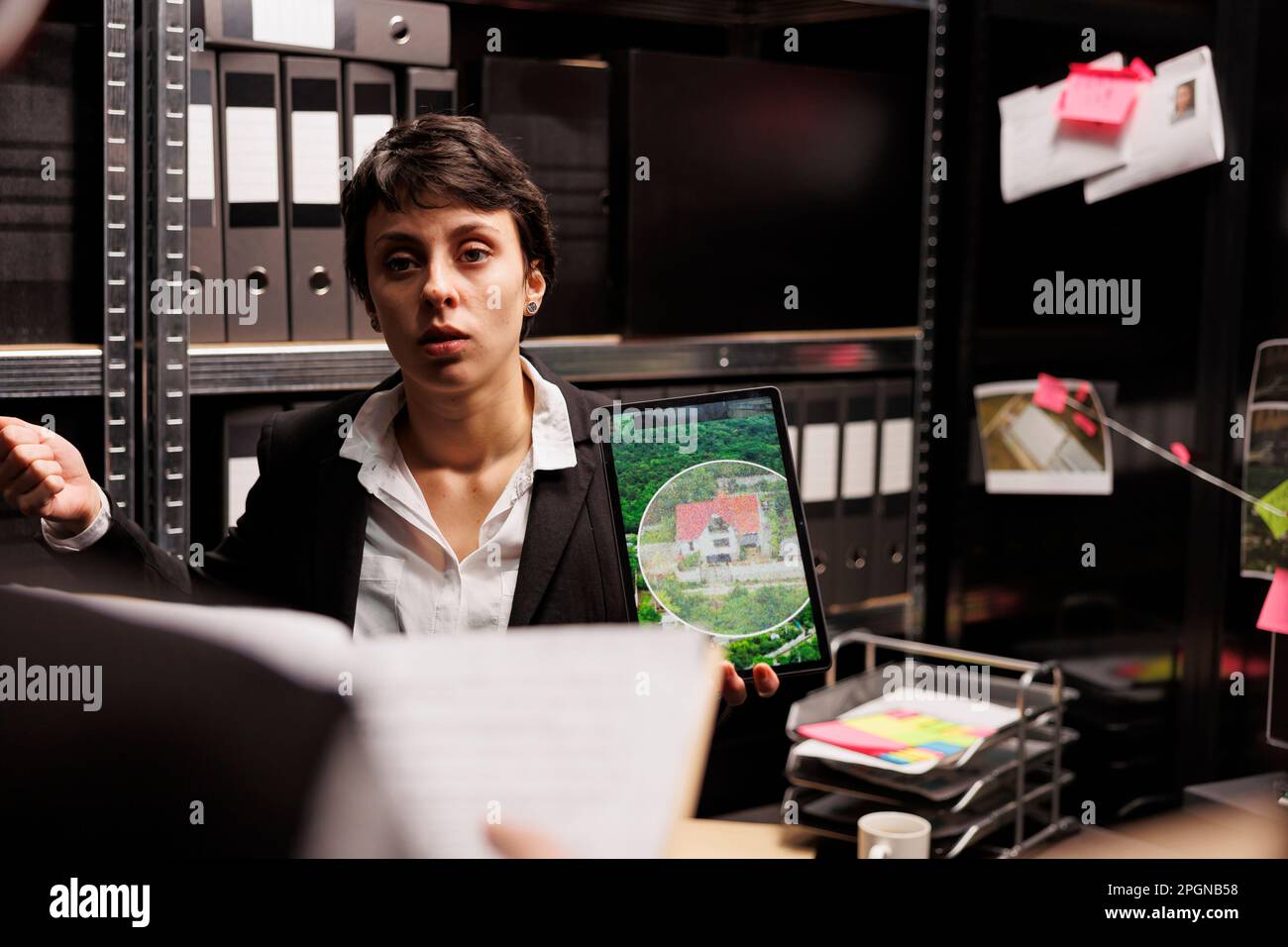 Woman Investigator Showing Crime Scene Photos On Tablet Computer