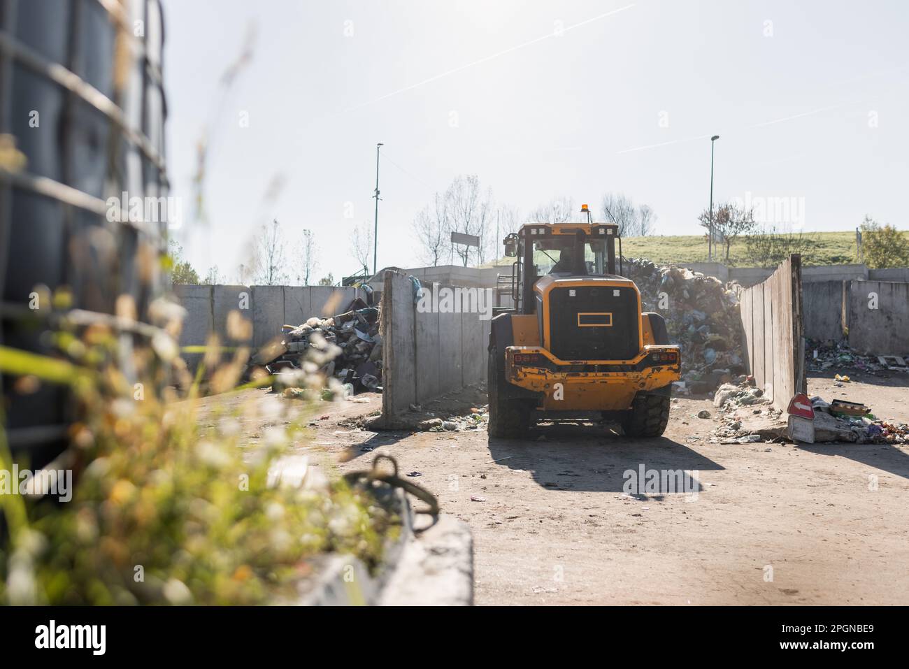 Front loader with scrap handling grapple bucket moving forward and ...