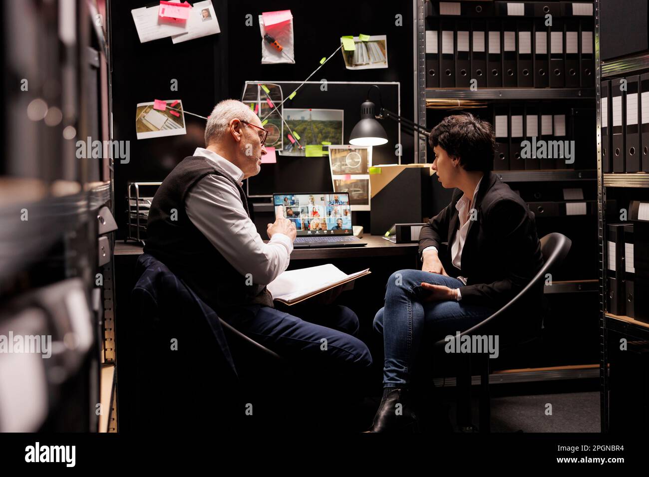 Private detectives discussing criminal case with investigators during ...