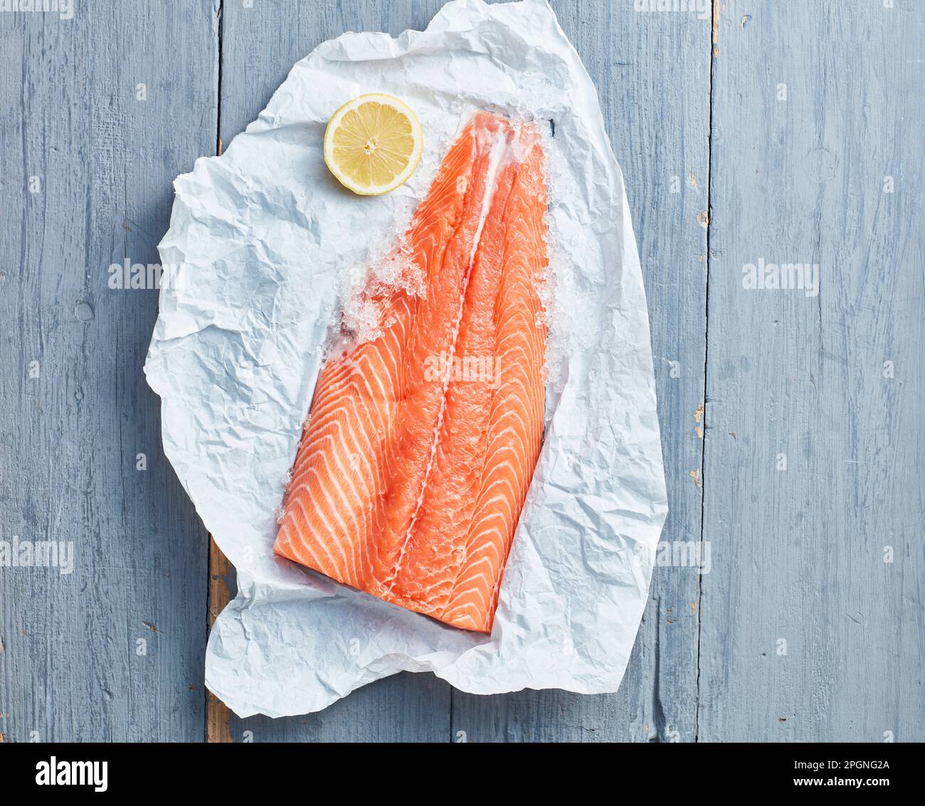 Raw salmon fillet lying on piece of paper Stock Photo - Alamy
