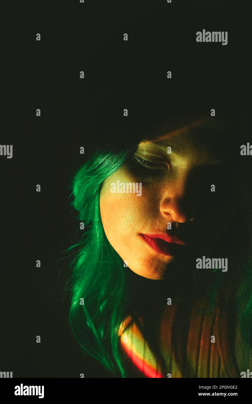 Woman's face with illuminated lighting over black background Stock ...