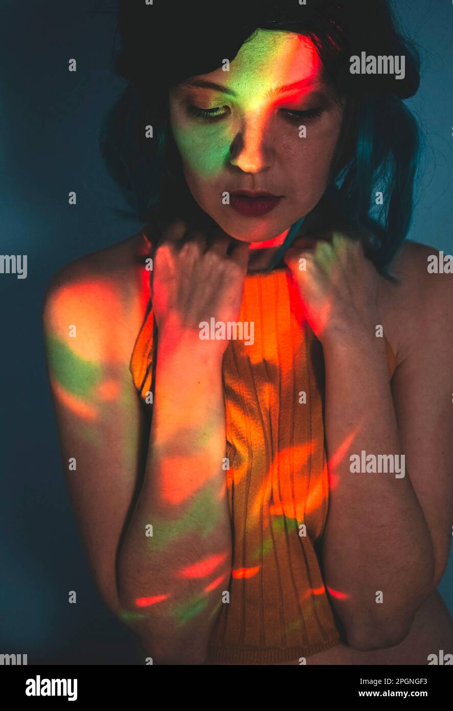 Woman with illuminated lights in front of wall Stock Photo - Alamy