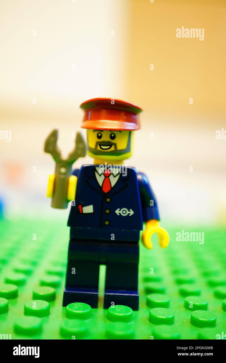 An overjoyed Lego mini-figure in a conductor costume stands with their ...