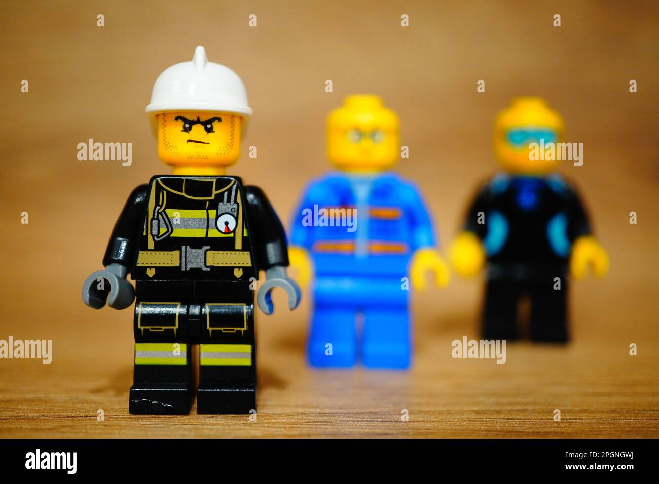 A LEGO fire fighter standing in a protective helmet, ready for action ...