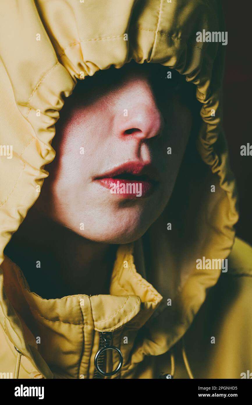 Woman wearing yellow hooded jacket Stock Photo - Alamy