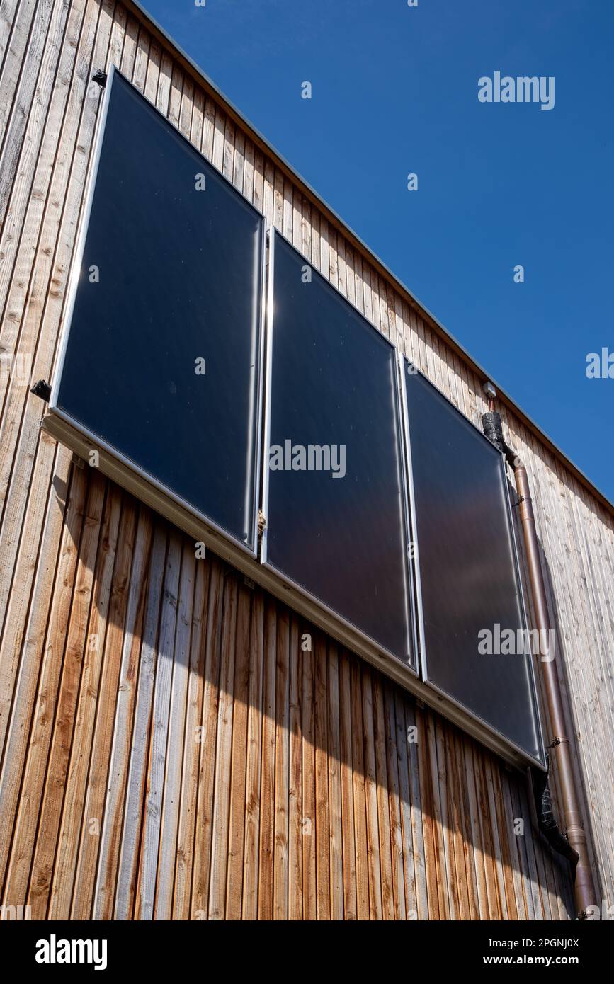 Solar collector on wooden house facade Stock Photo - Alamy