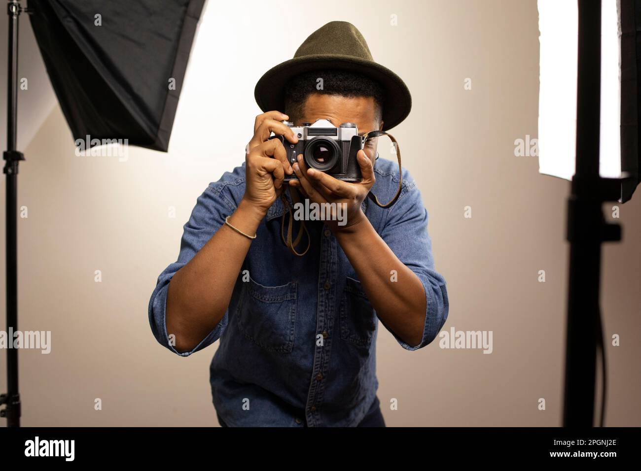 Man clicking photo using camera in studio Stock Photo - Alamy Man clicking photo using camera in studio Stock Photo - Alamy