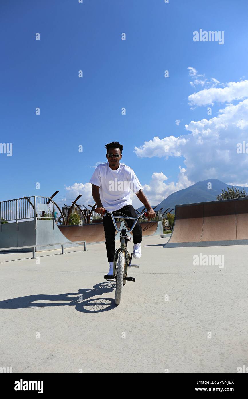 Young man riding BMX bike at skatepark Stock Photo - Alamy