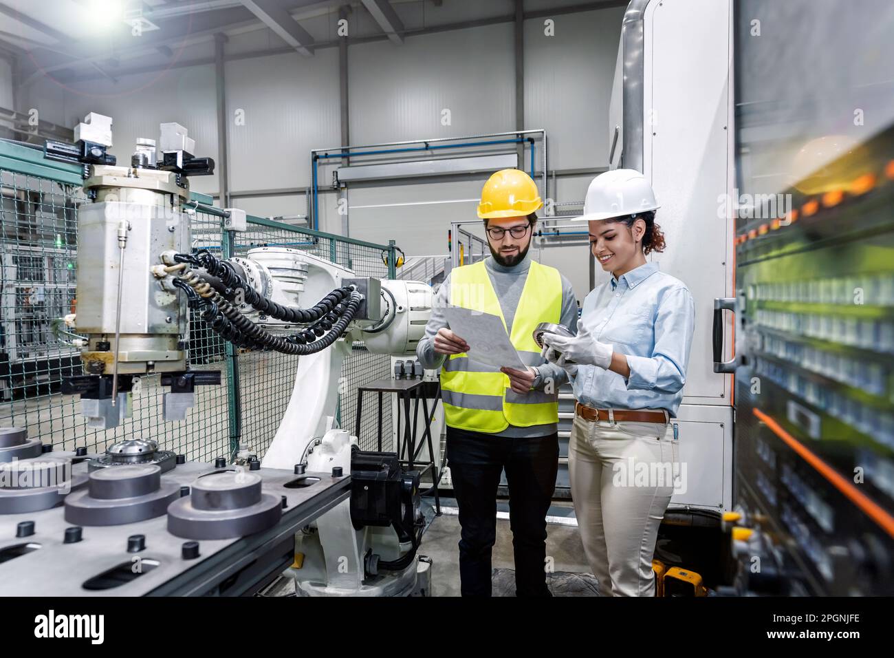 Business people standing with blueprint in factory Stock Photo - Alamy