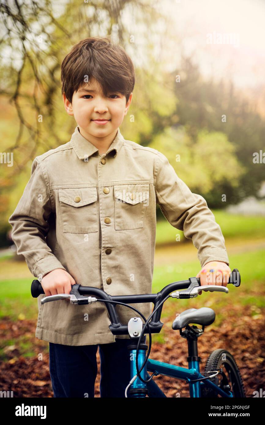 Boy standing with bicycle hi-res stock photography and images - Alamy