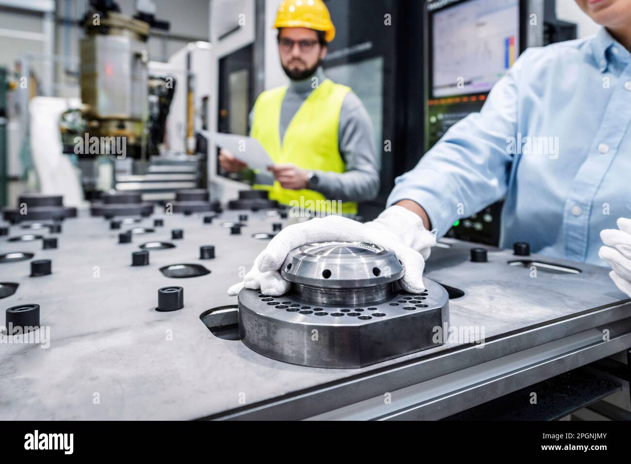 Hand of technician wearing glove touching machine part in factory Stock ...