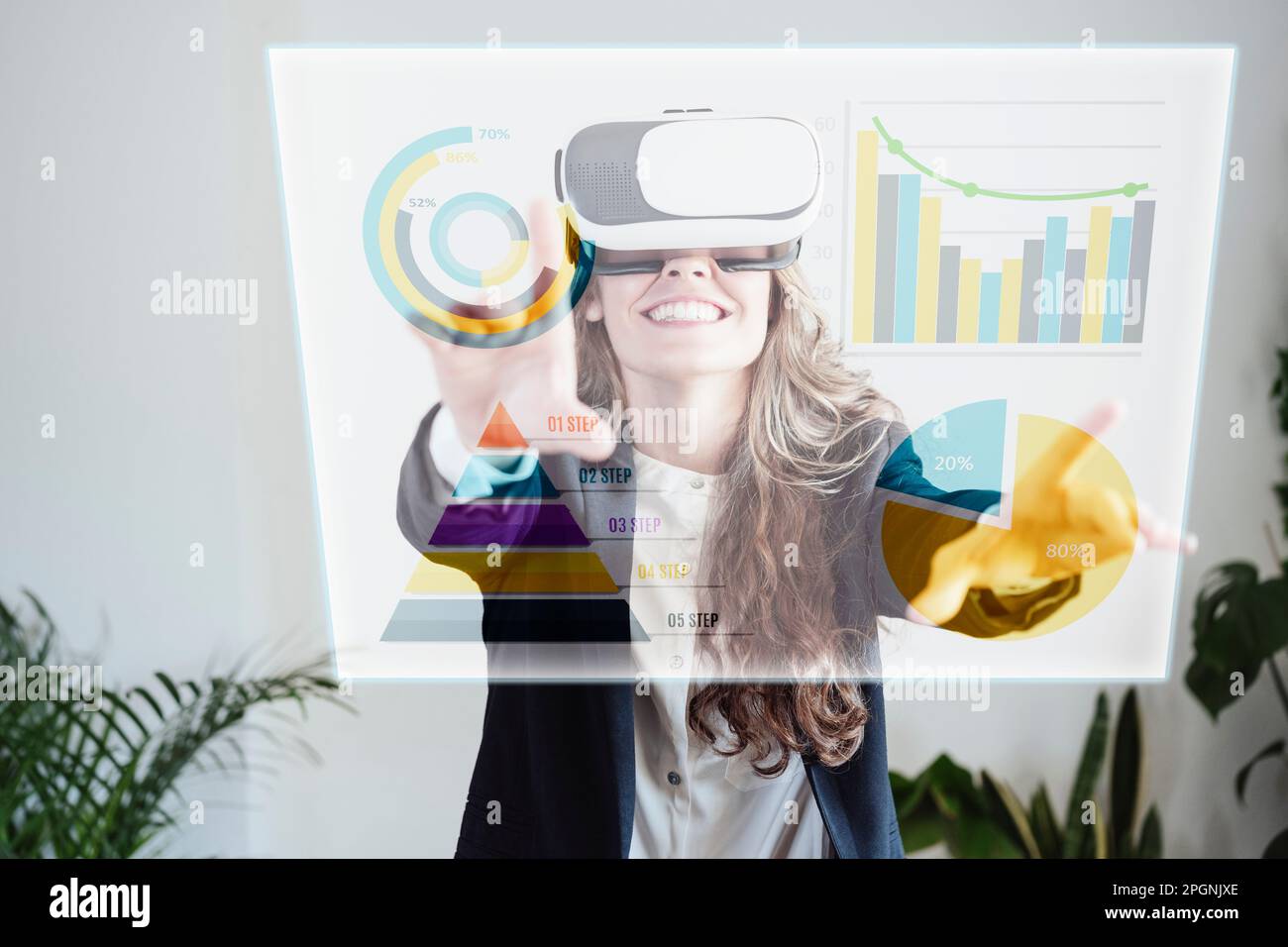 Happy businesswoman wearing VR goggles and examining graphs and pie charts Stock Photo - Alamy