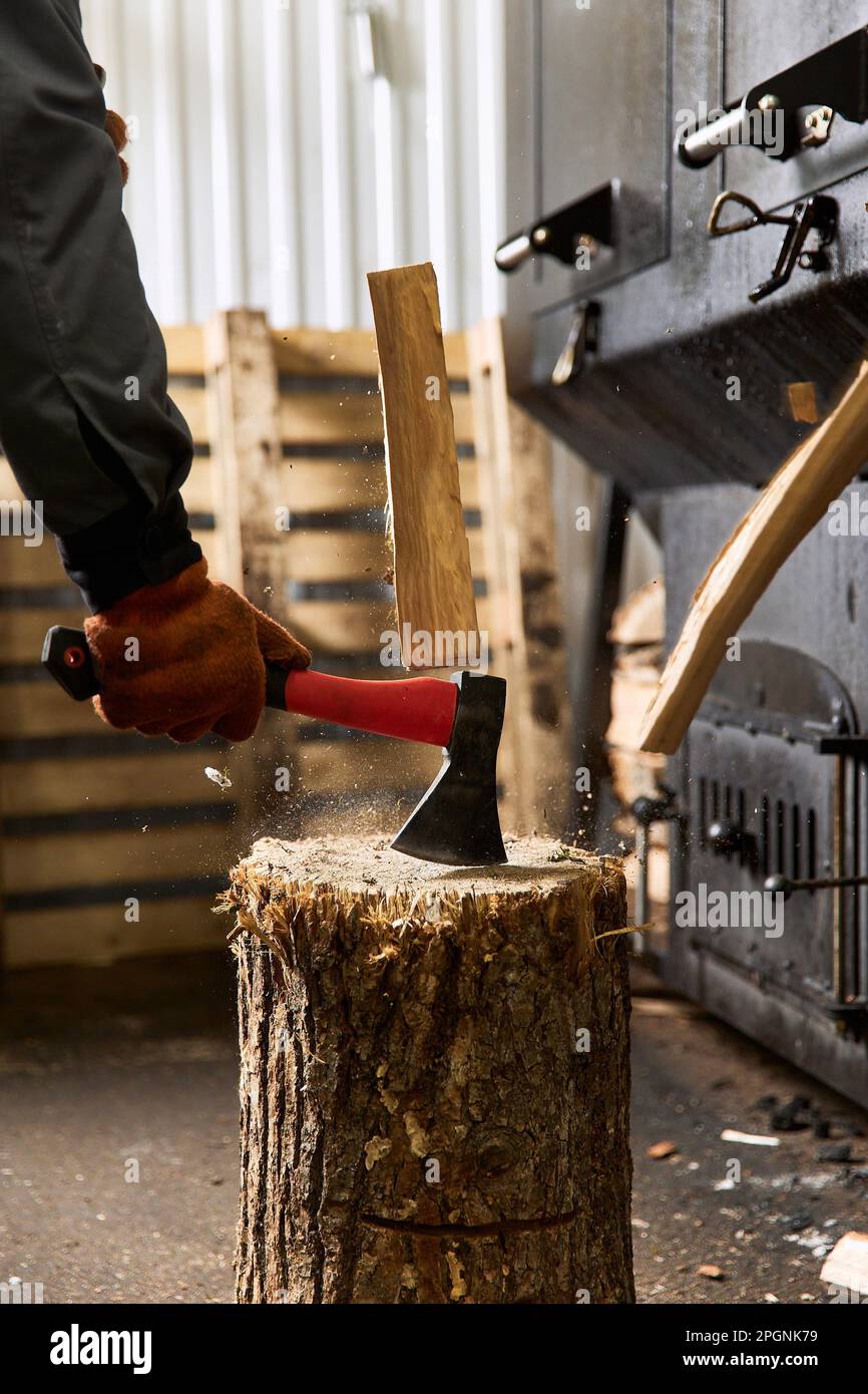 Man cutting firewood with axe Stock Photo - Alamy