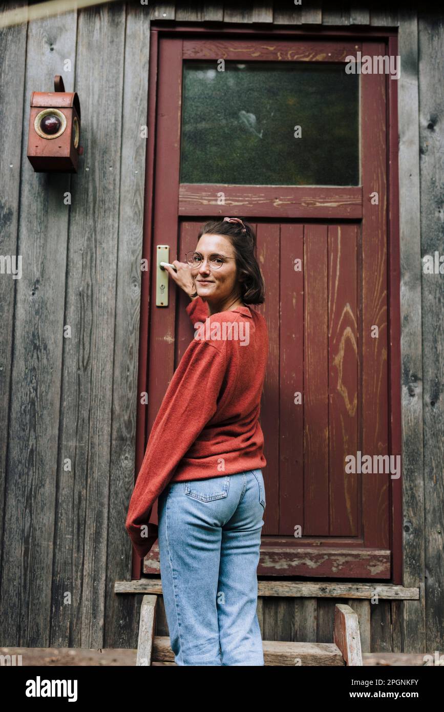 Woman opening front door rear view hi-res stock photography and images ...