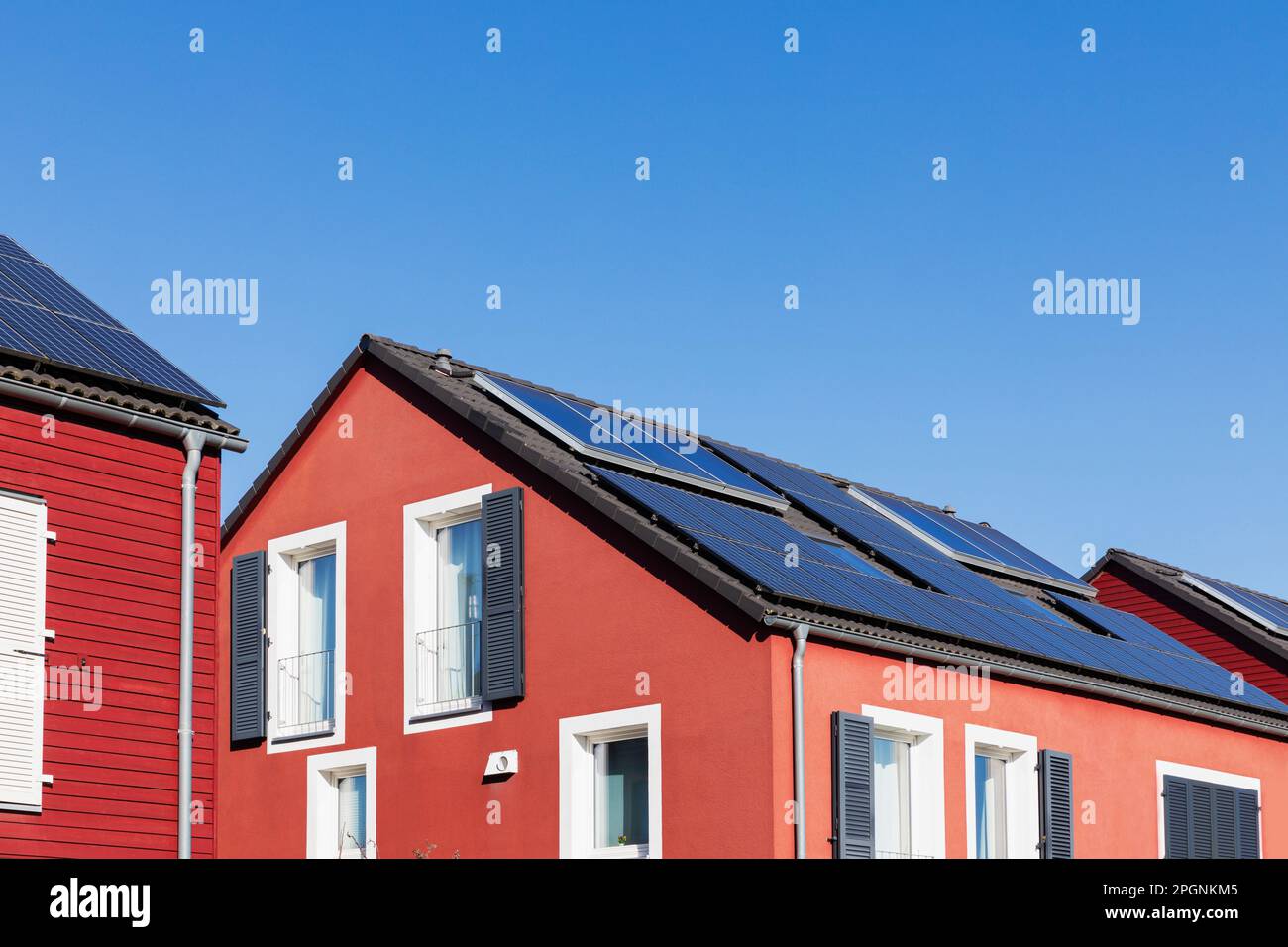 Row red painted wooden houses solar roof panels hi-res stock ...