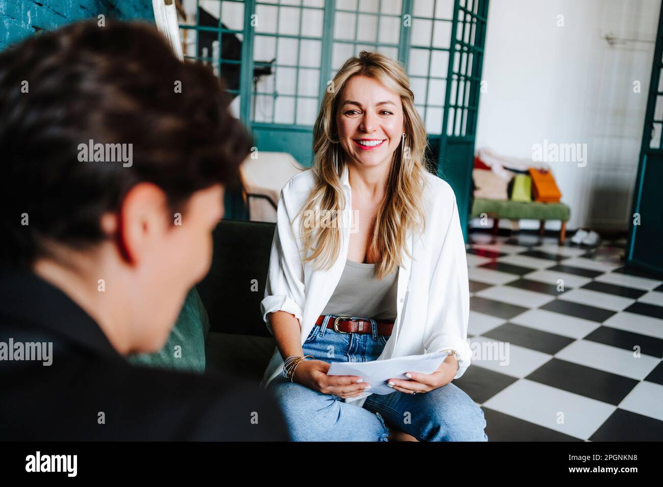 Happy actress holding documents by producer on film set Stock Photo - Alamy