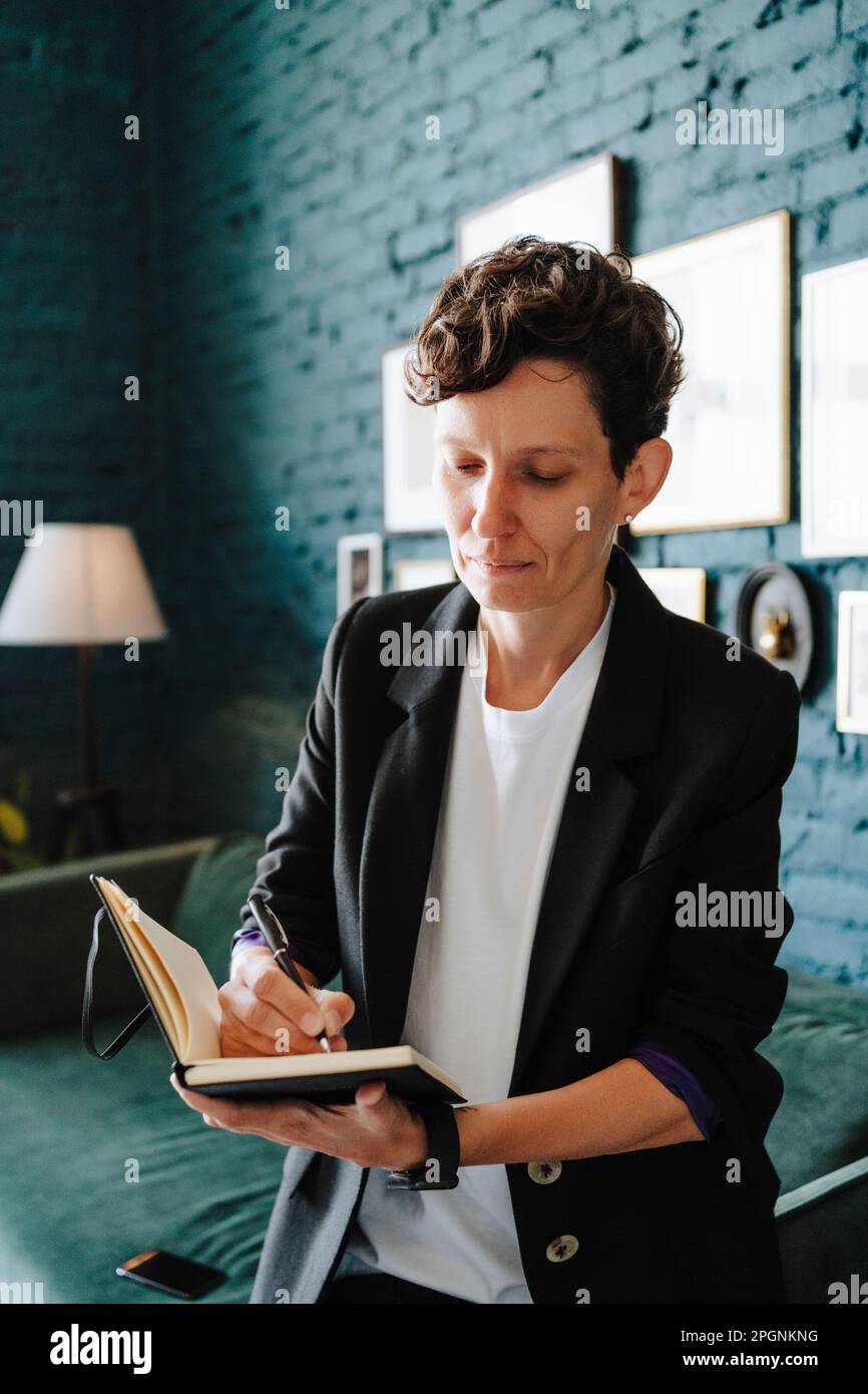 Producer writing in book at film set Stock Photo - Alamy