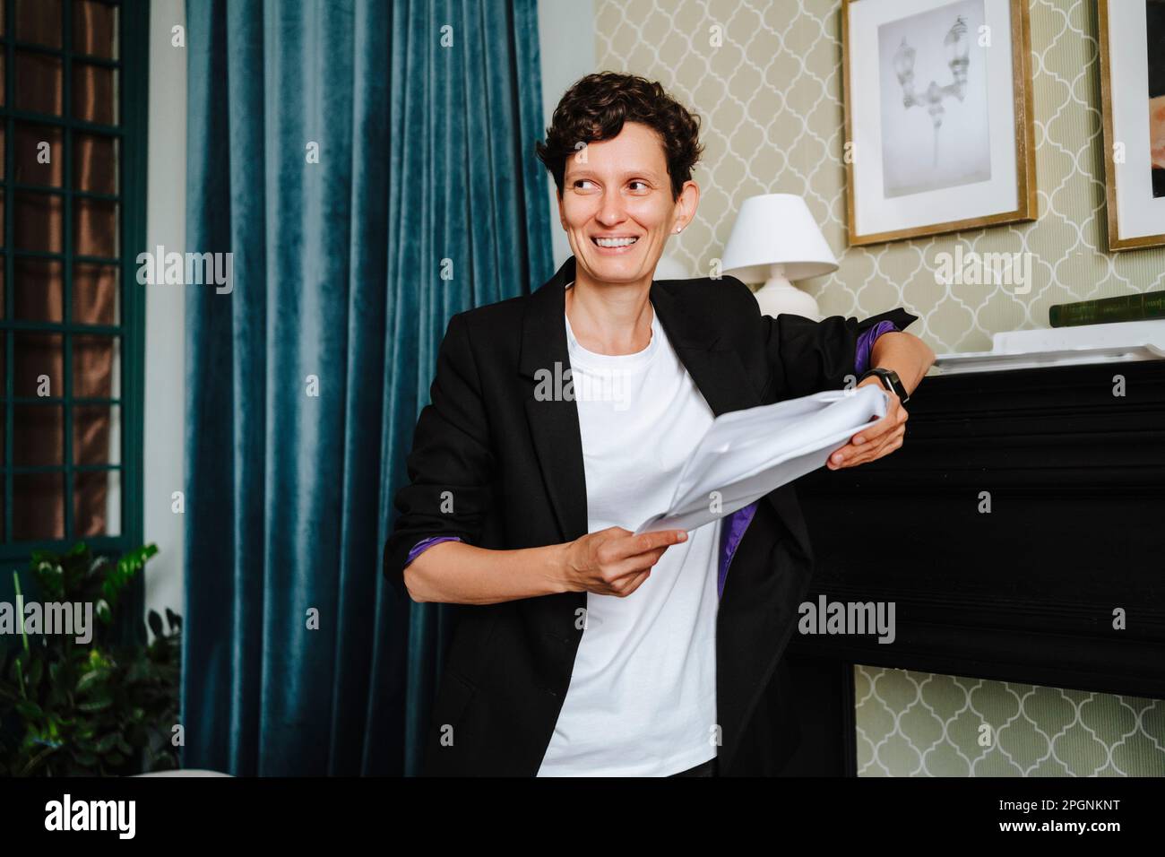 Smiling director holding script at film set Stock Photo - Alamy