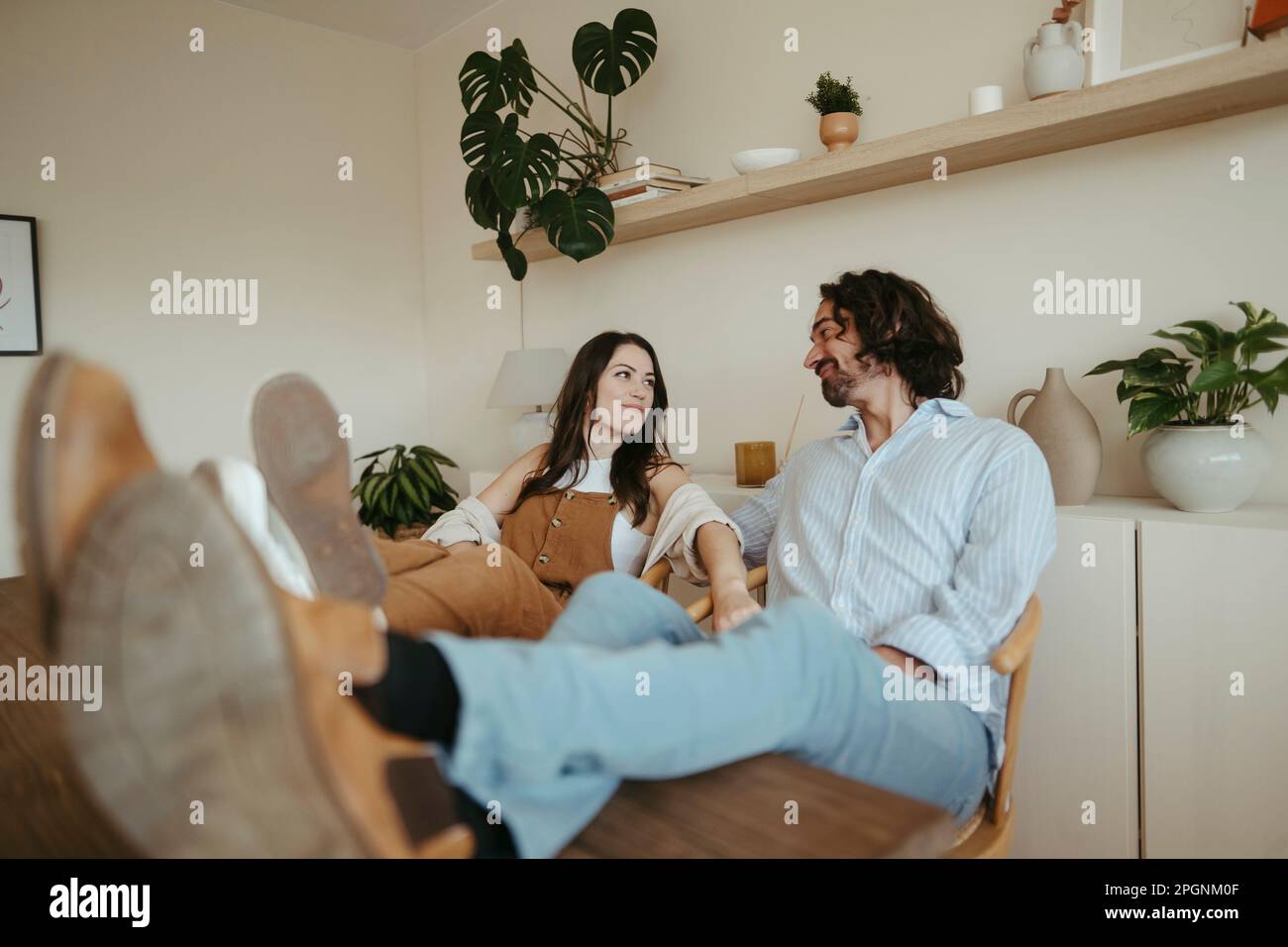 Couple with feet up sitting at home Stock Photo - Alamy