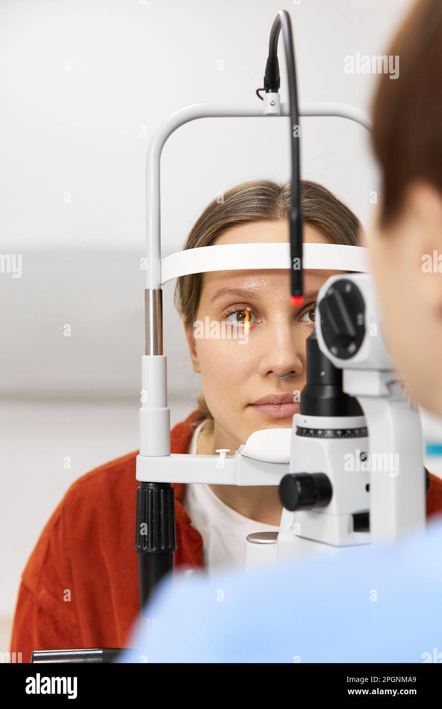 Patient undergoing vision diagnostics test at clinic Stock Photo - Alamy