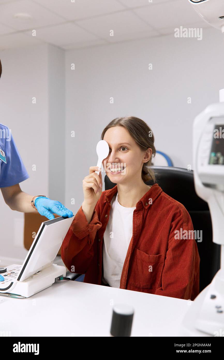 Happy patient doing eye check up at hospital Stock Photo - Alamy