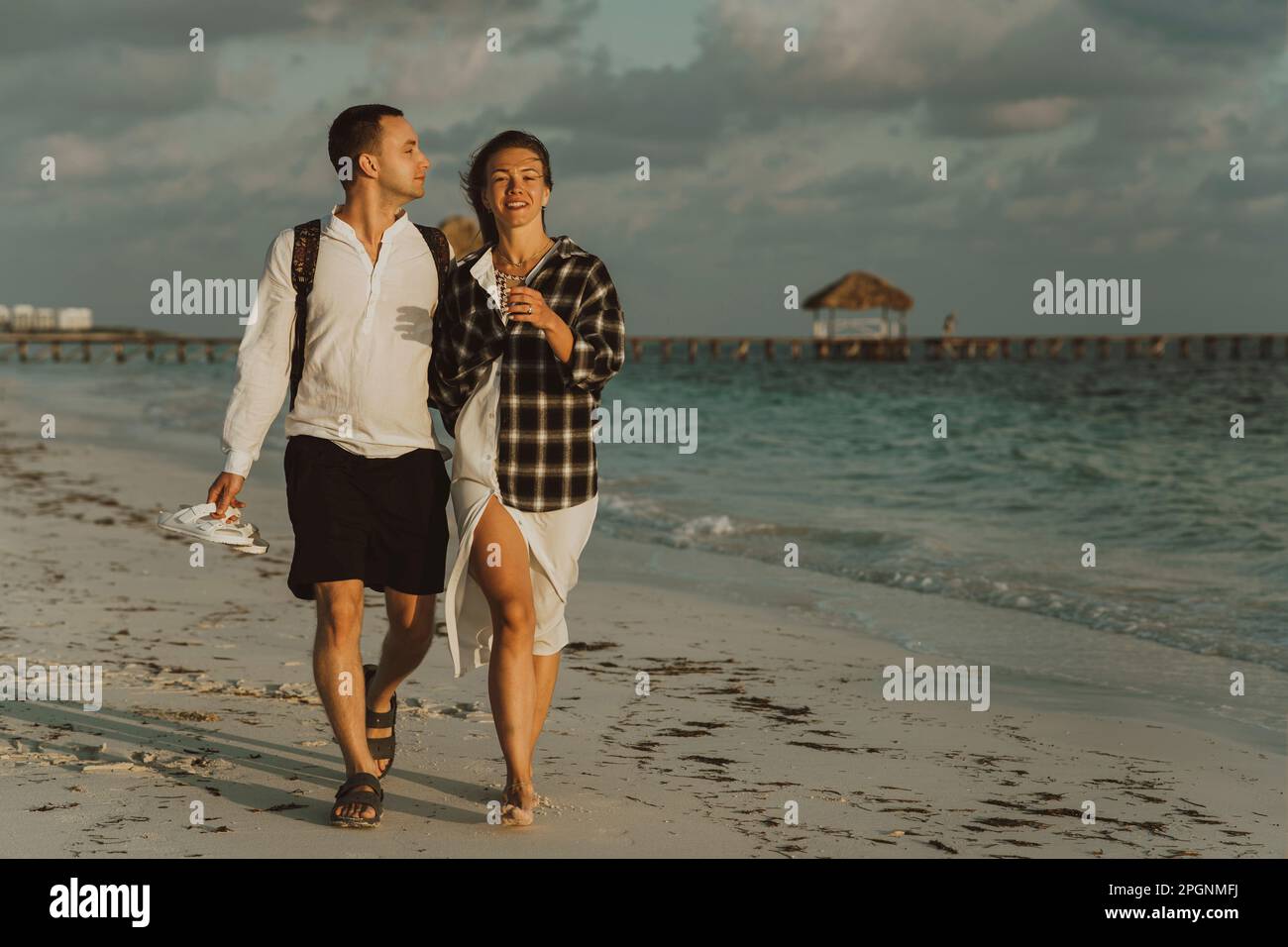 Boyfriend and girlfriend walking on sand at beach Stock Photo - Alamy