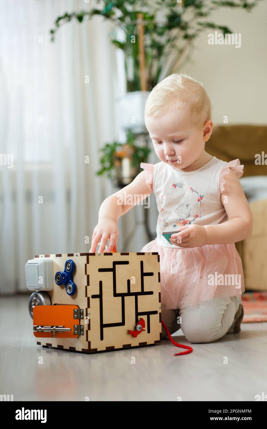 wonderful preschool activity. Girl playing stacking toy, simple puzzle ...