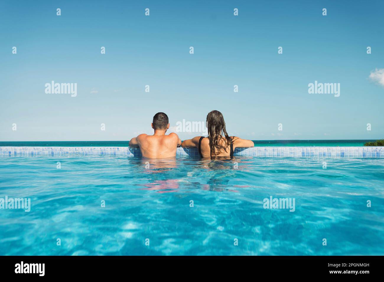 Boyfriend and girlfriend enjoying together in swimming pool Stock Photo - Alamy
