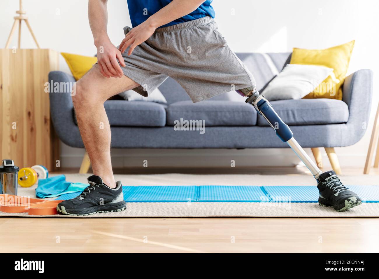 Man with amputated leg stretching in living room Stock Photo - Alamy