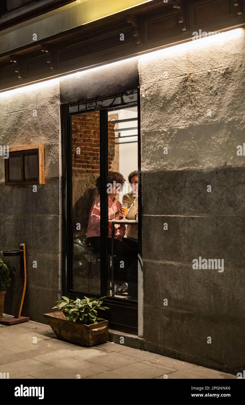 Friends having dinner seen through window of restaurant Stock Photo - Alamy