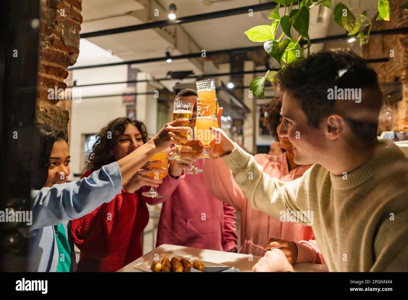 Happy friends restaurant dinner beer hi-res stock photography and ...