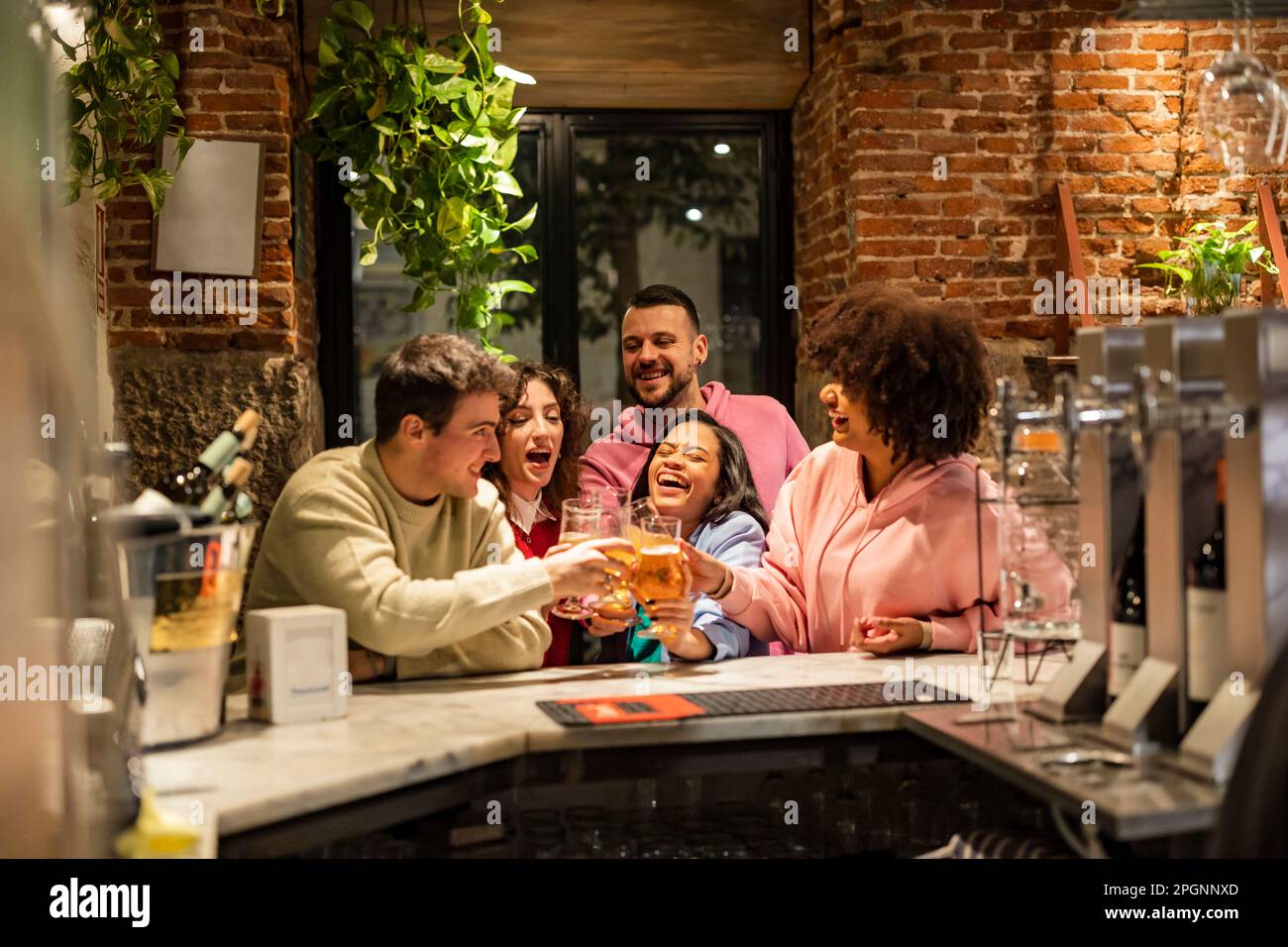Happy multiracial friends at bar counter having fun in restaurant Stock ...
