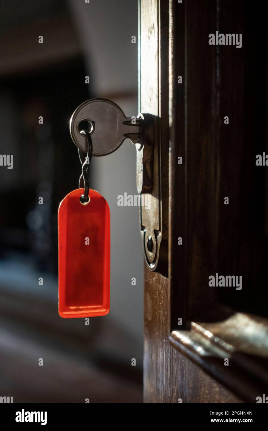 Key in lock of front door Stock Photo - Alamy