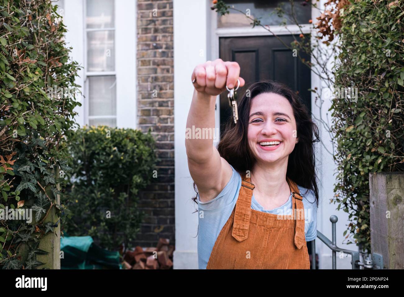Happy woman showing new home keys Stock Photo - Alamy