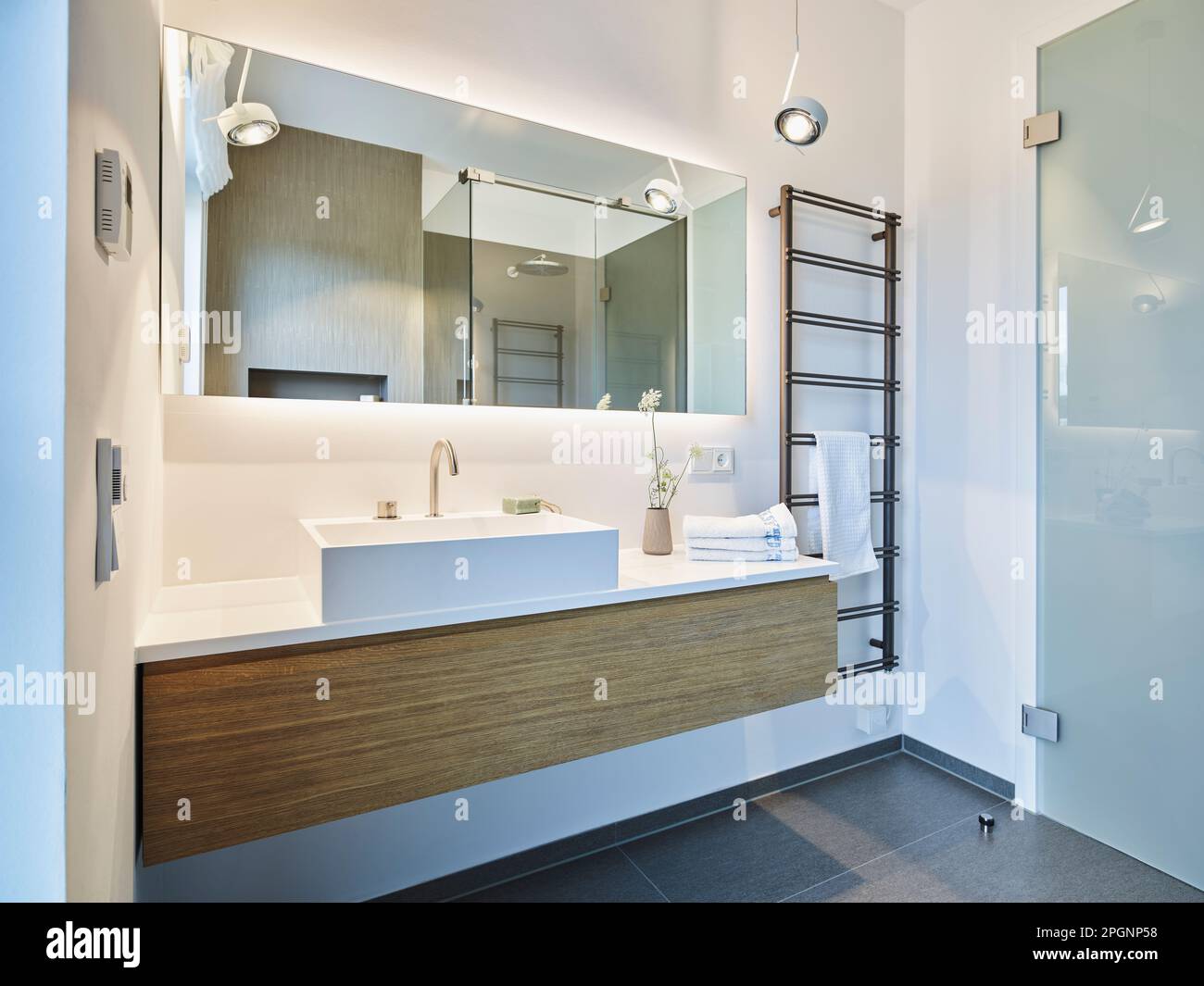 Wash basin with mirror mounted on wall in apartment Stock Photo - Alamy