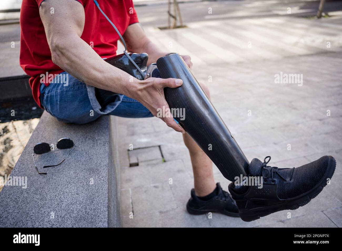 Man with disability adjusting prosthetic leg sitting on seat Stock ...